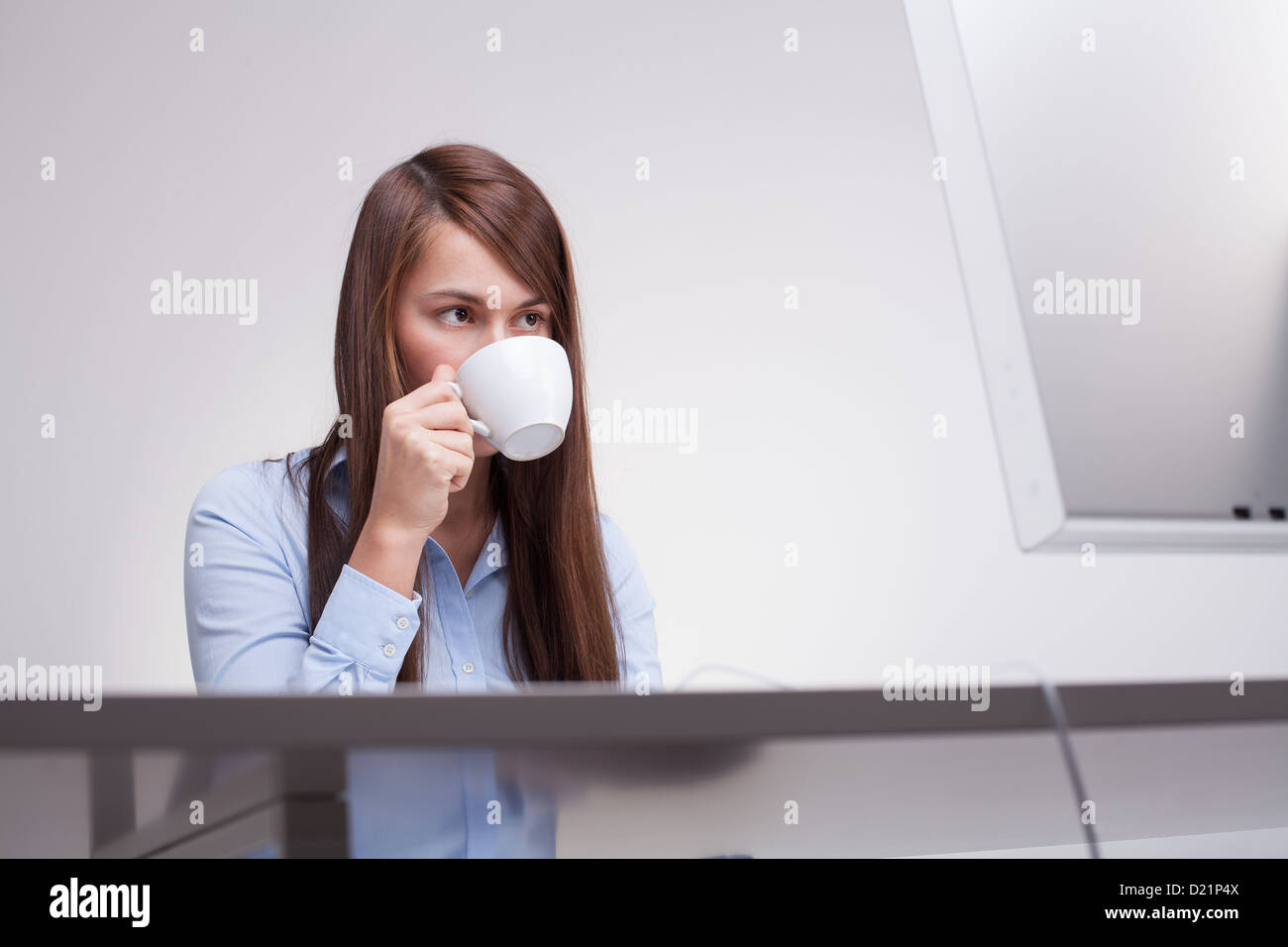 Beautiful woman with cup at work Stock Photo - Alamy