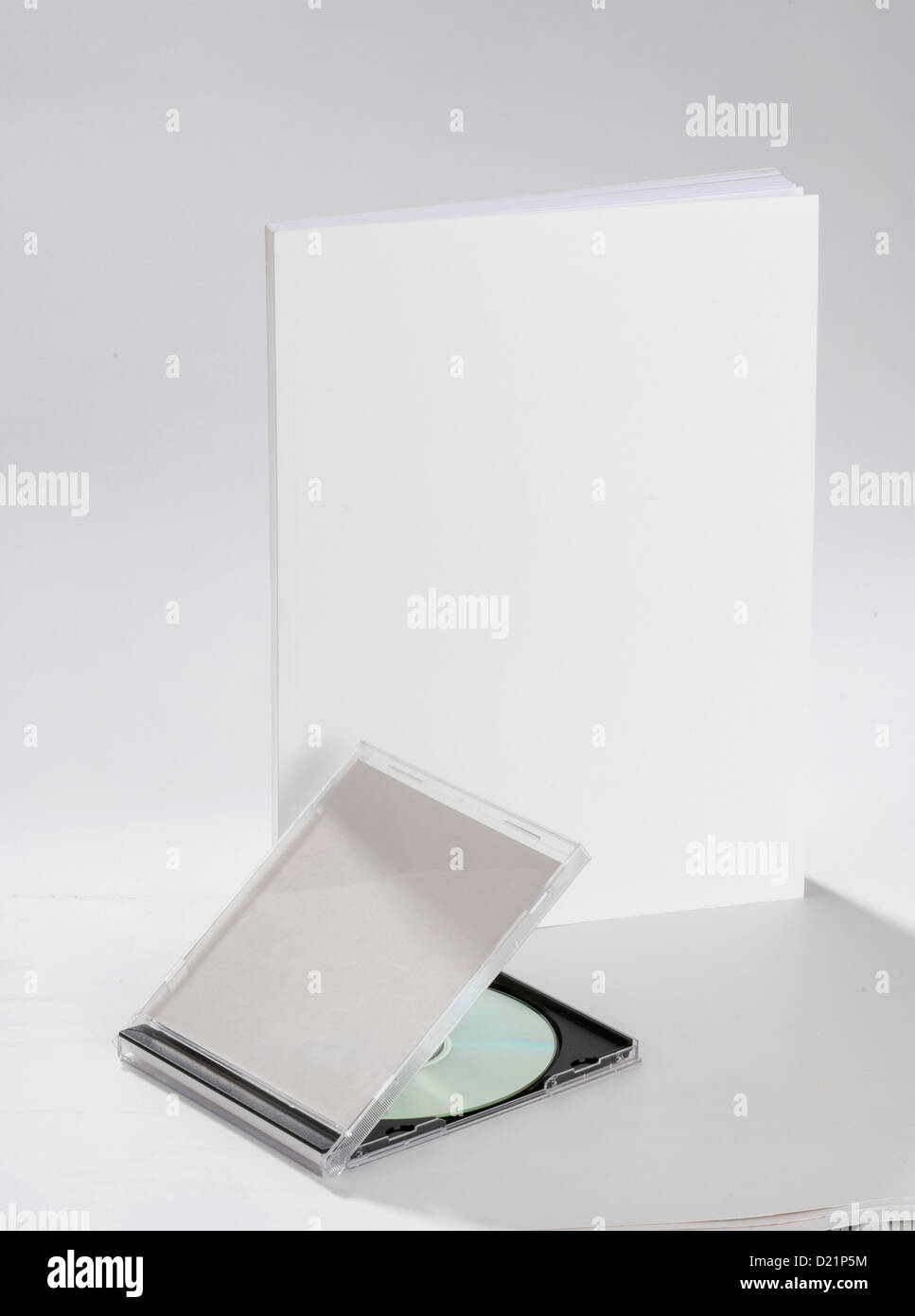 Blank CD and book on white ground Stock Photo - Alamy