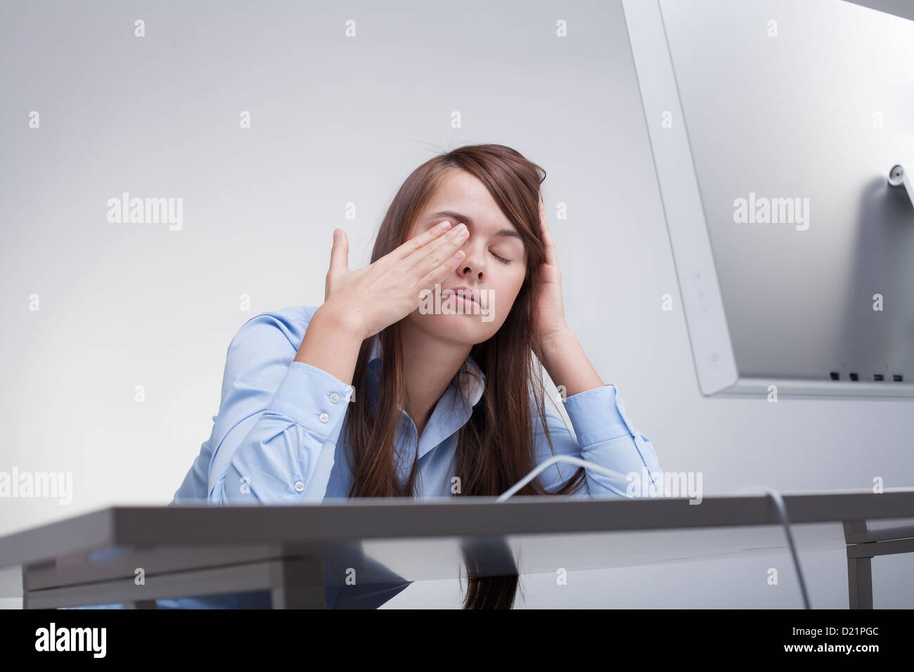 Beautiful woman tired at work Stock Photo - Alamy