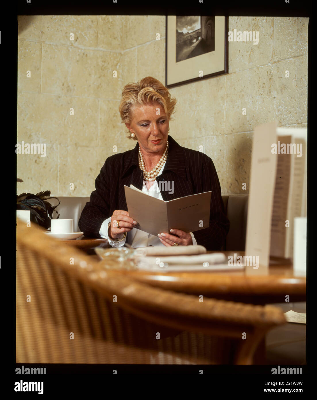 Woman Looking At Menu Stock Photo - Alamy