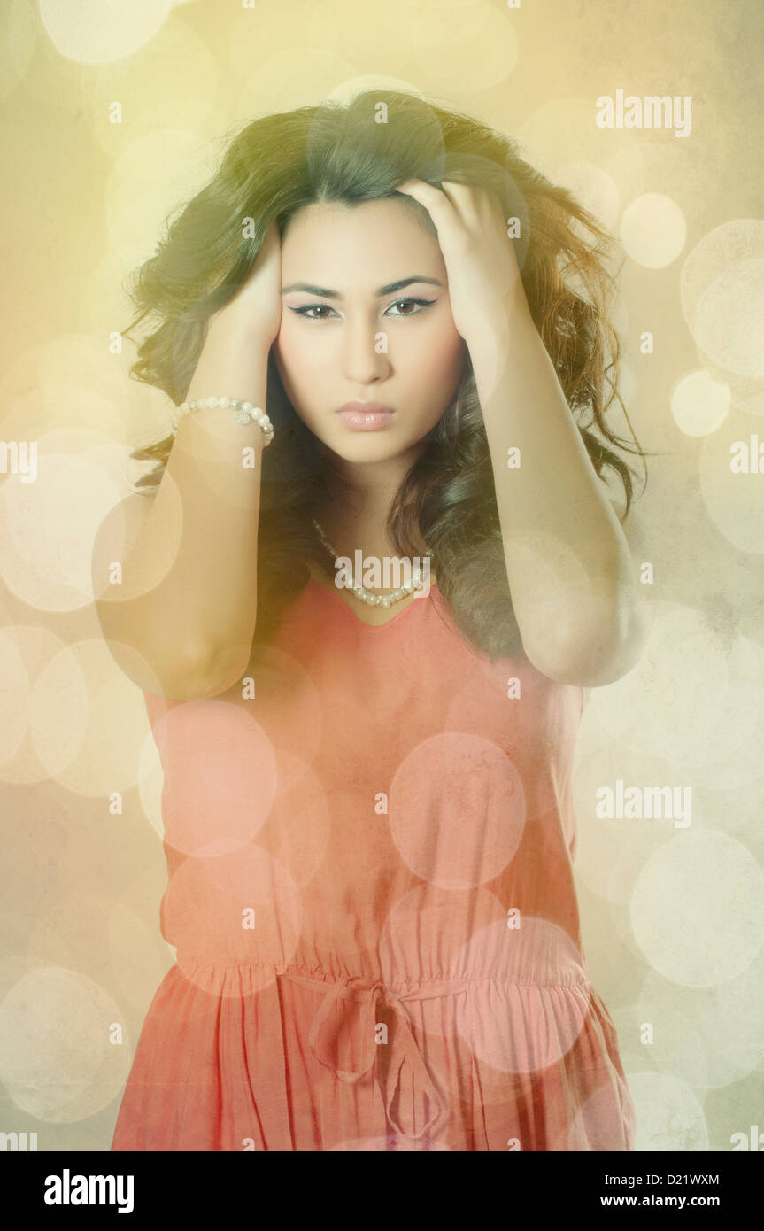 Beautiful young woman head in hands Stock Photo - Alamy