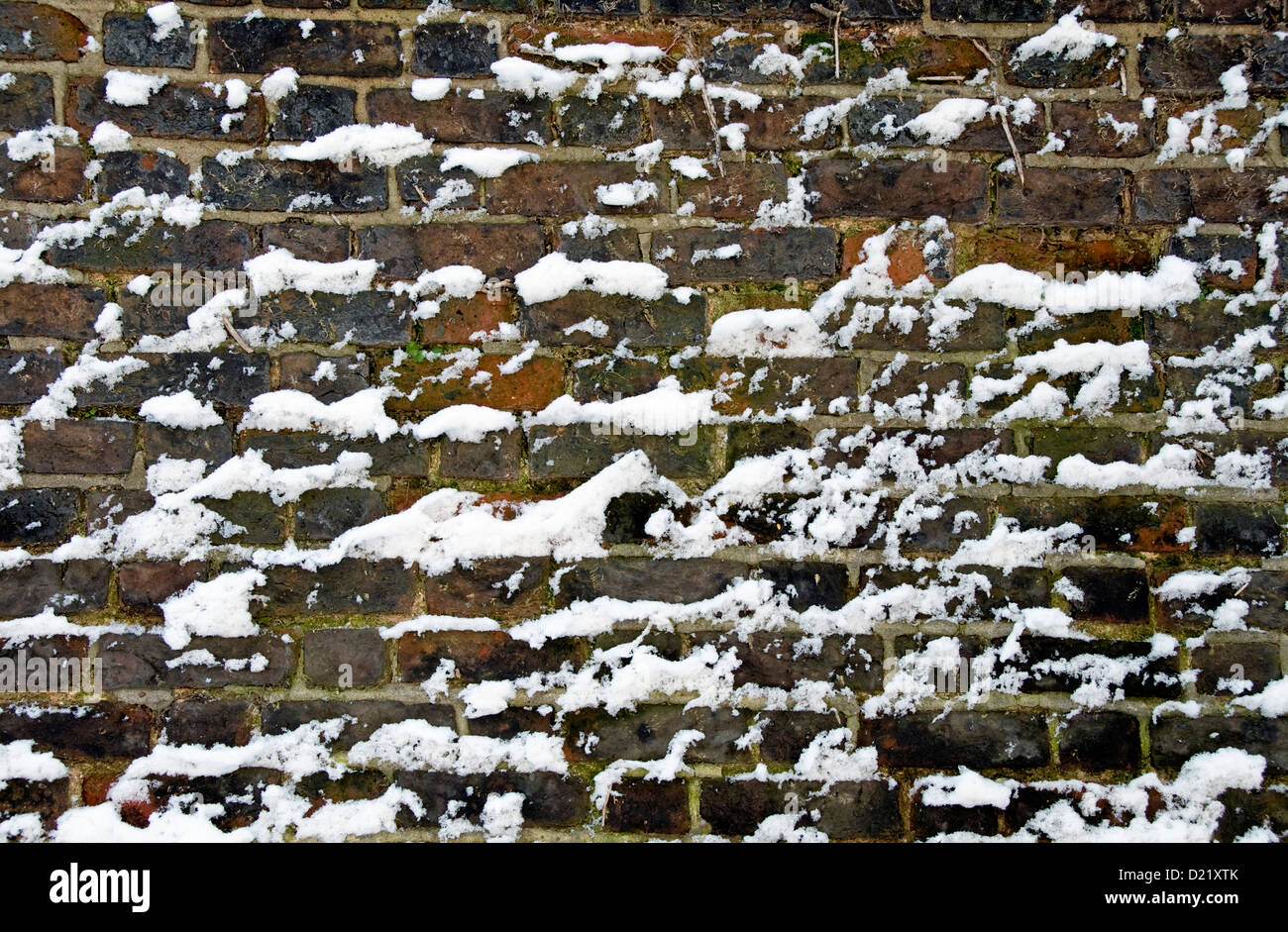 Snow clinging to brick wall Stock Photo - Alamy