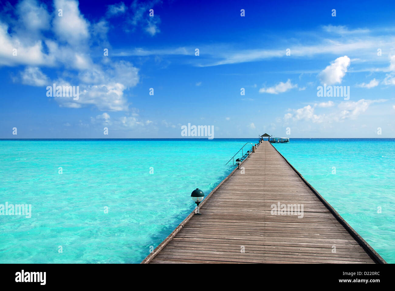 Wooden jetty over the beautiful Maldivian sea with blue sky Stock Photo ...