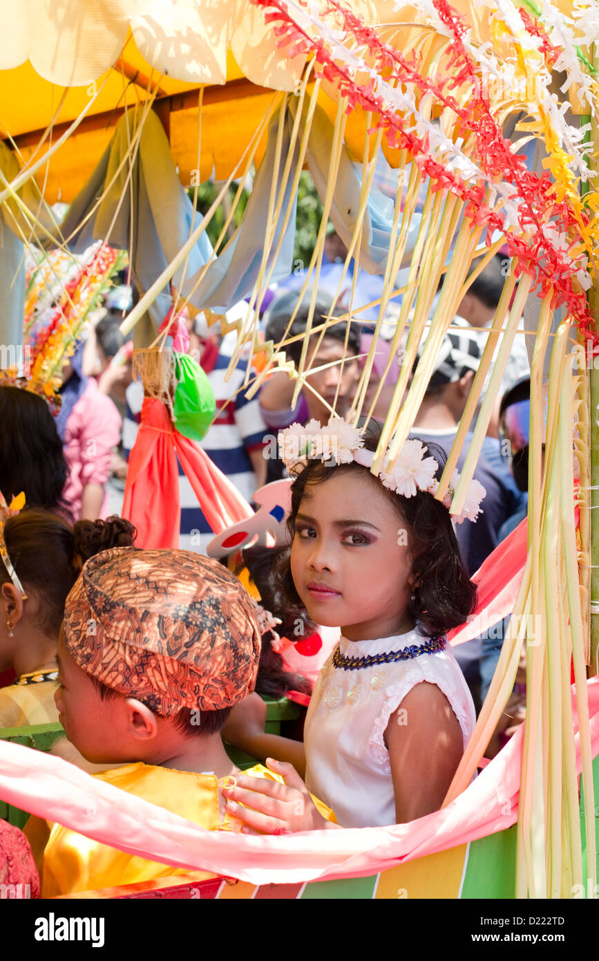 A group of children sit at the back of a float in a Harvest Festival ...