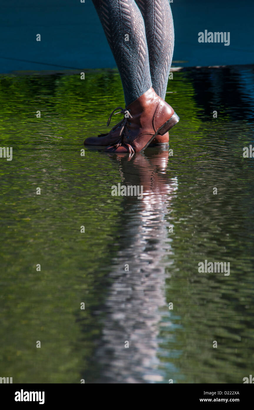 Young woman's feet in brown shoes wading in shallow water Stock Photo ...