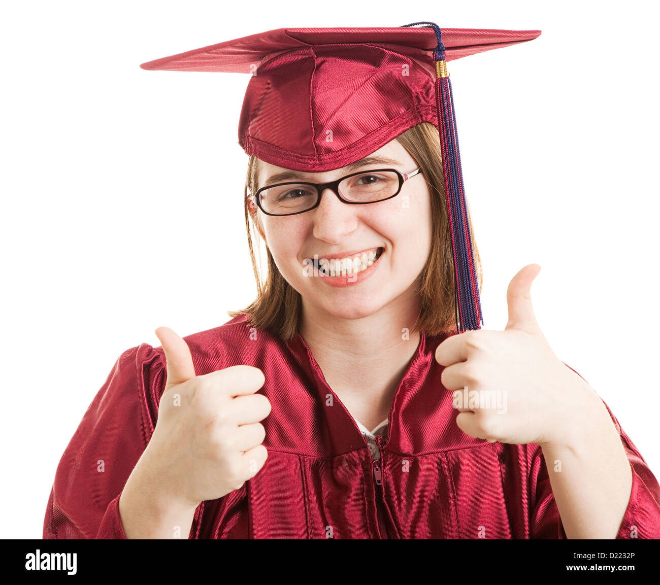 Young female college or high school graduate giving the thumbs up sign ...
