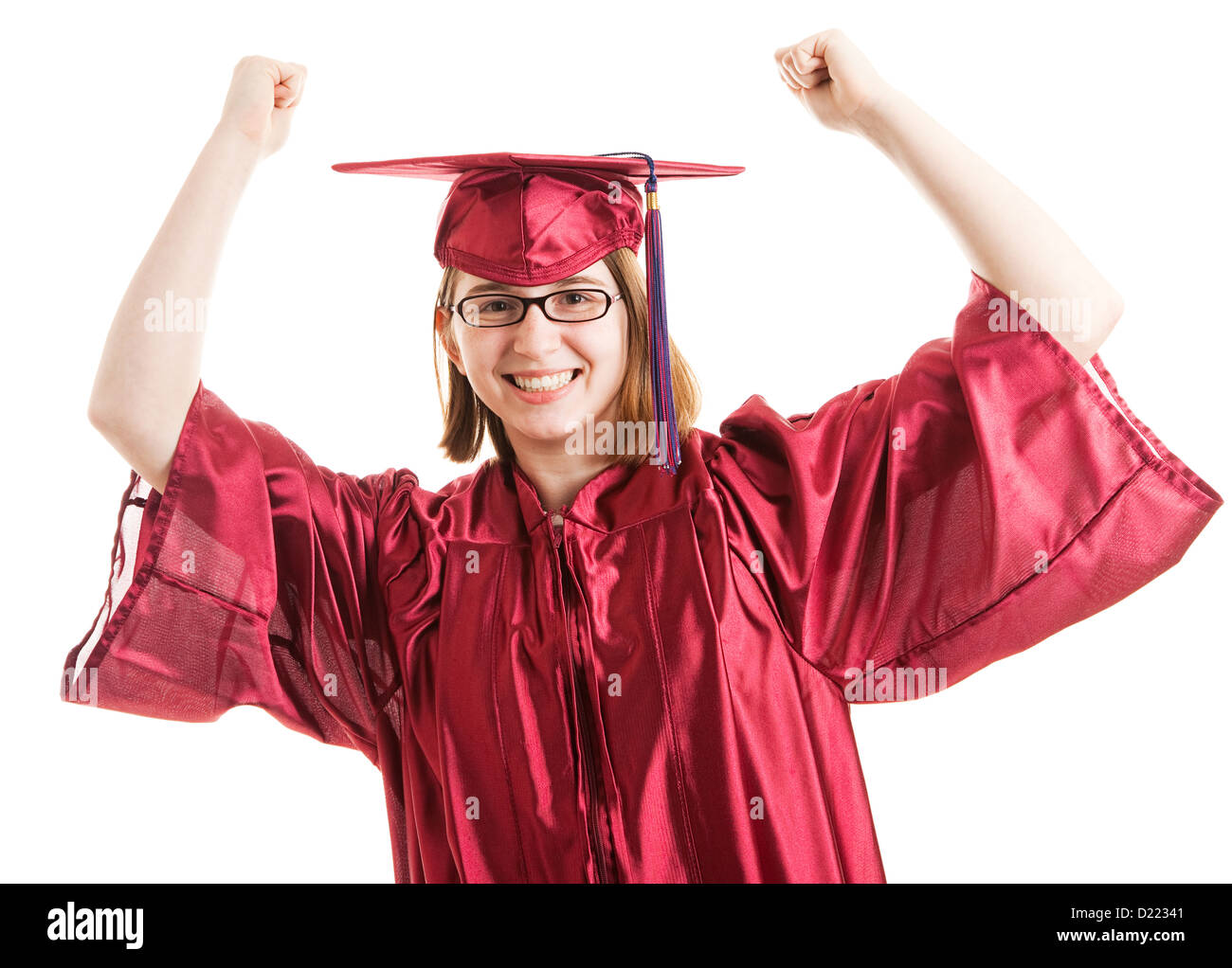 Female graduate in her cap and gown, raising her arms in a gesture of ...