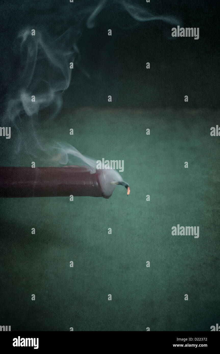 Extinguished red candle Stock Photo - Alamy