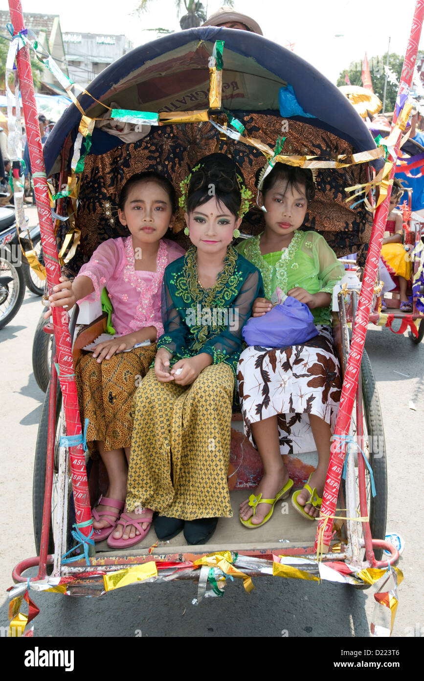 A group of girls sit at the front of a converted rickshaw in a Harvest ...