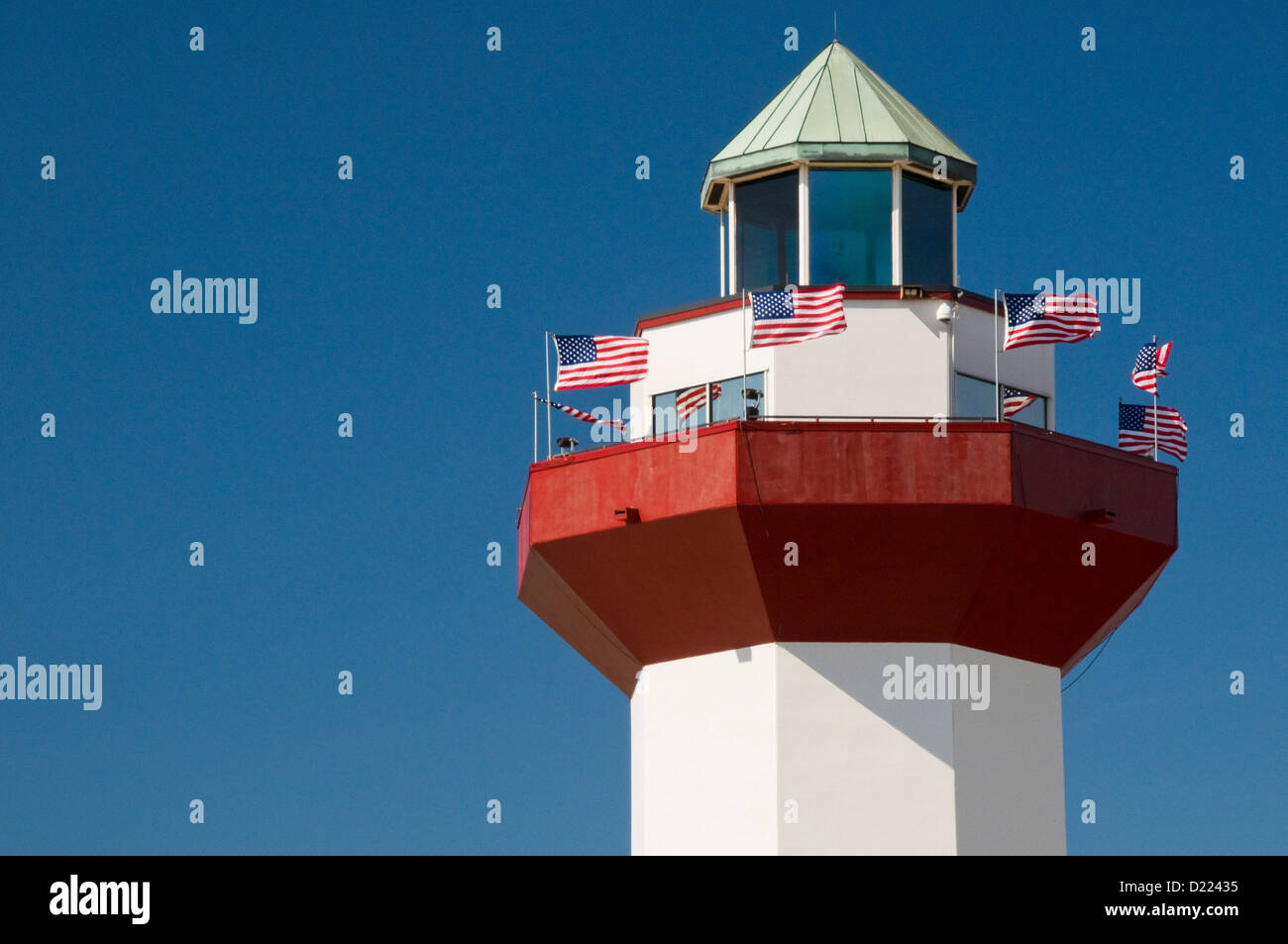American Flags blow in the air on the famous Harbour Town Lighthouse on ...
