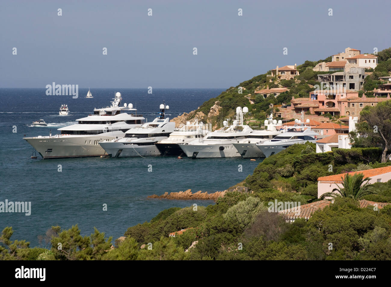 Sardinia: Porto Cervo - large 'yachts' at anchor with town in ...