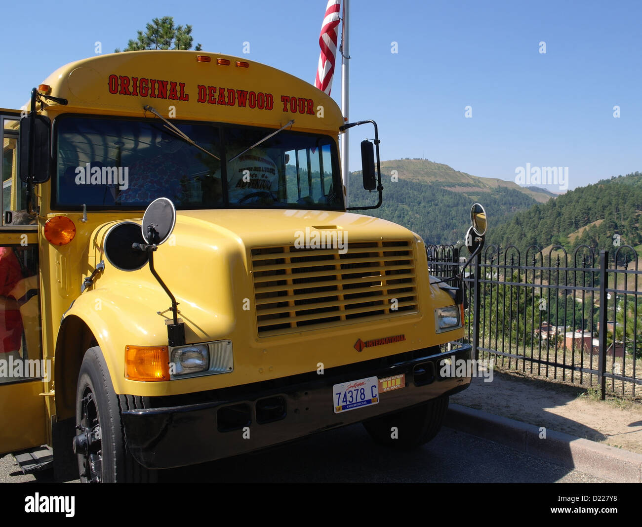 Tourists entering front doors yellow 'Original Deadwood Tour Bus ...