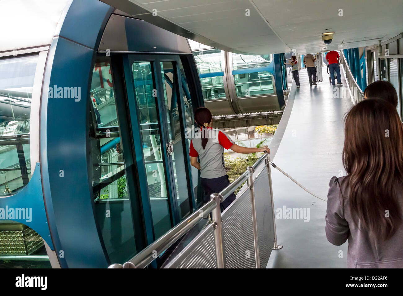 Attendant preparing Singapore Flyer cabin for passengers Stock Photo ...