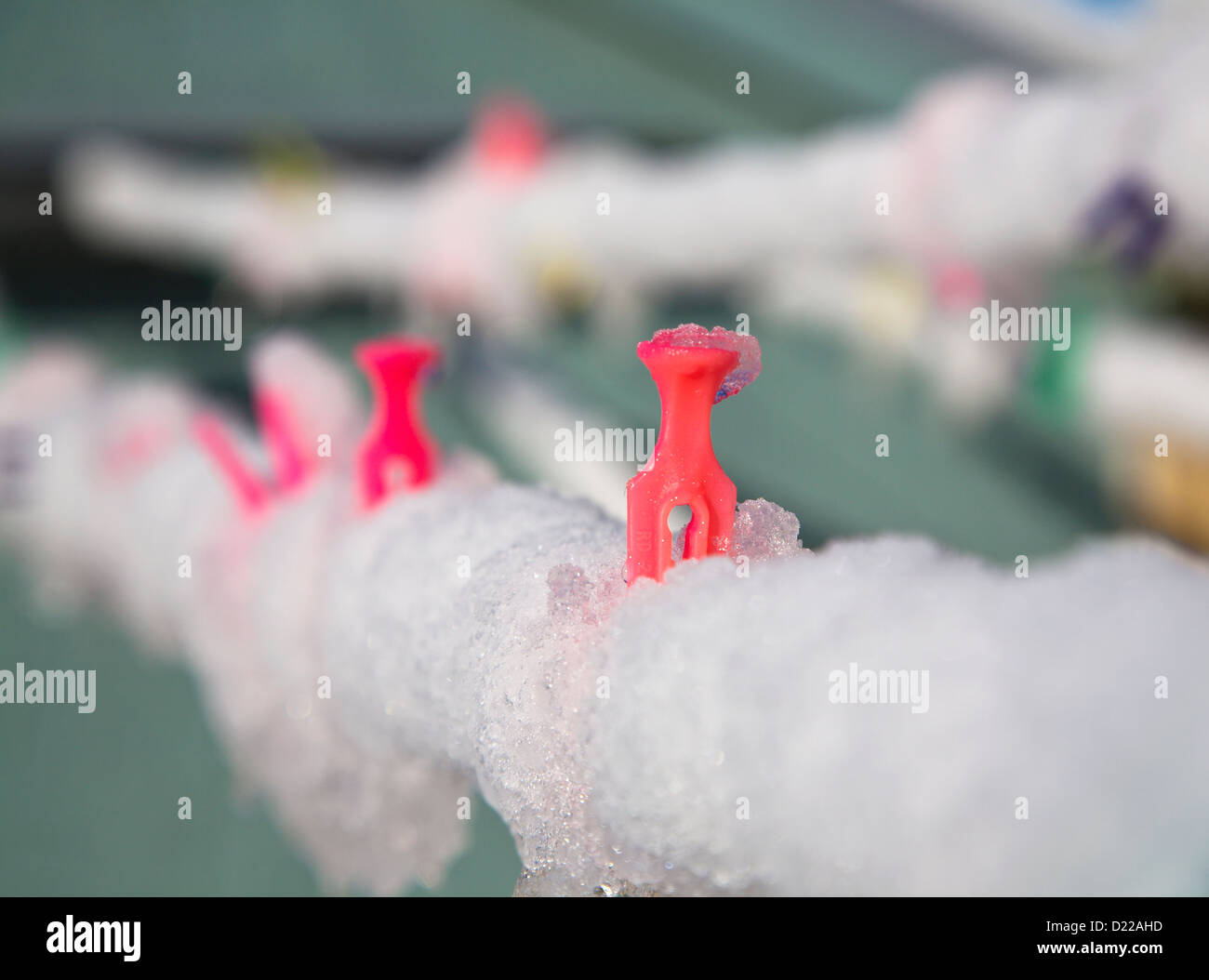 Colourful pegs on a washing line covered in ice and snow. Christchurch ...
