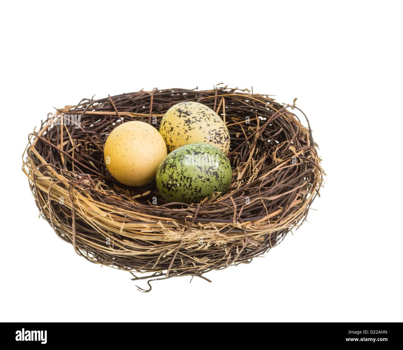 A bird's nest with colorful eggs isolated on white Stock Photo - Alamy