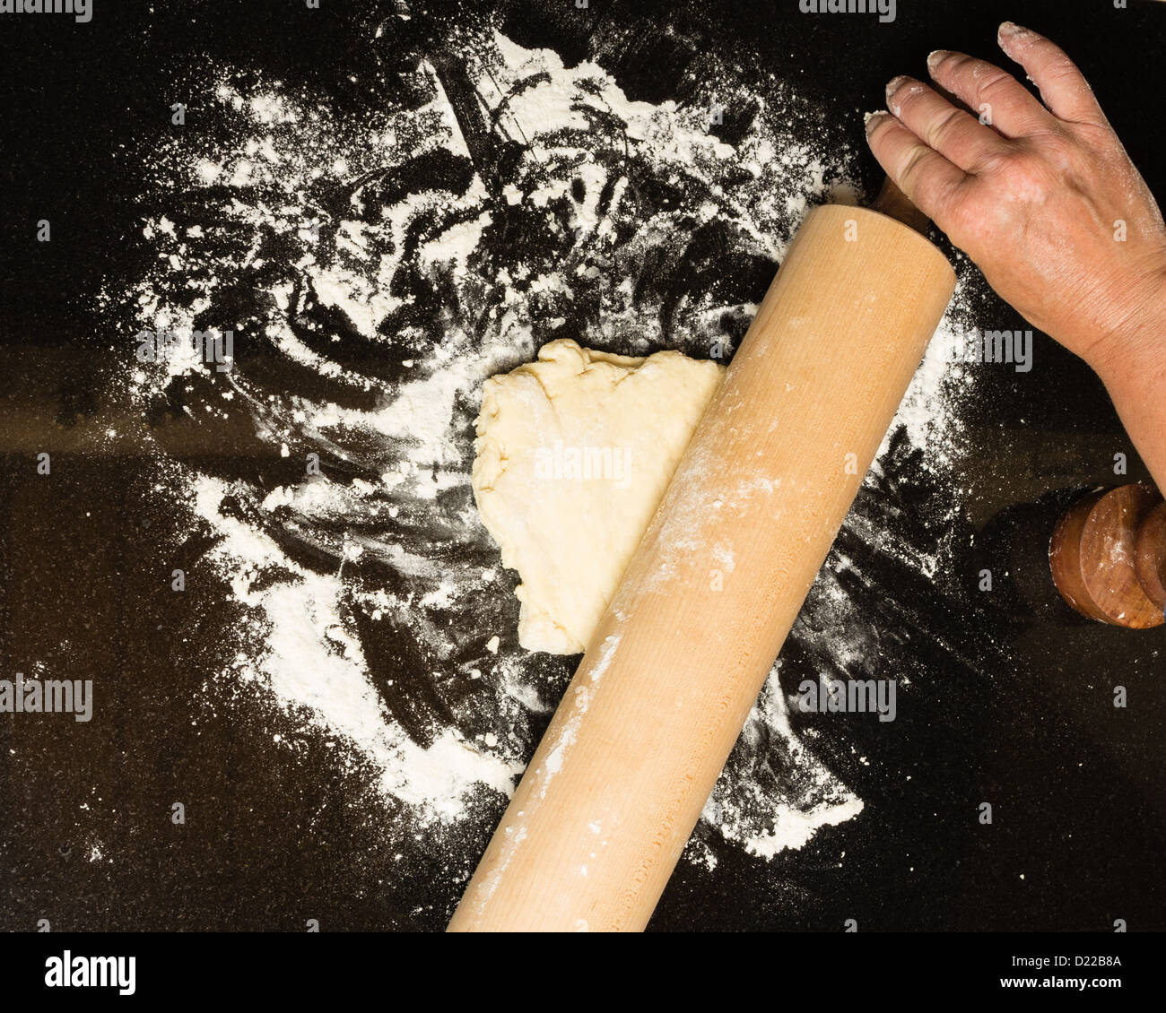 Baker rolling out dough for biscuits Stock Photo - Alamy