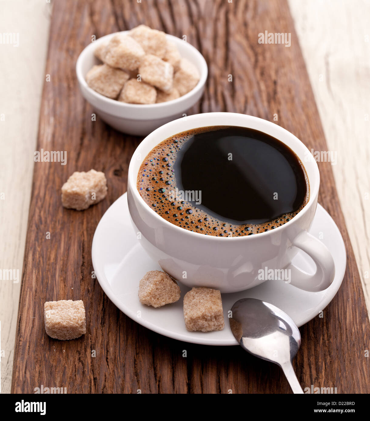 Cup of coffee with brown sugar on a light wooden table Stock Photo - Alamy