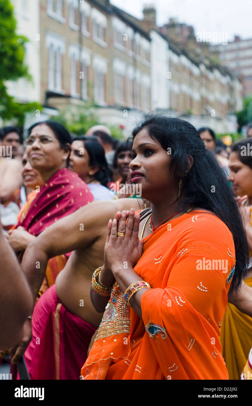 A woman waits to have her fruit bowl blessed as Hindus celebrate the ...
