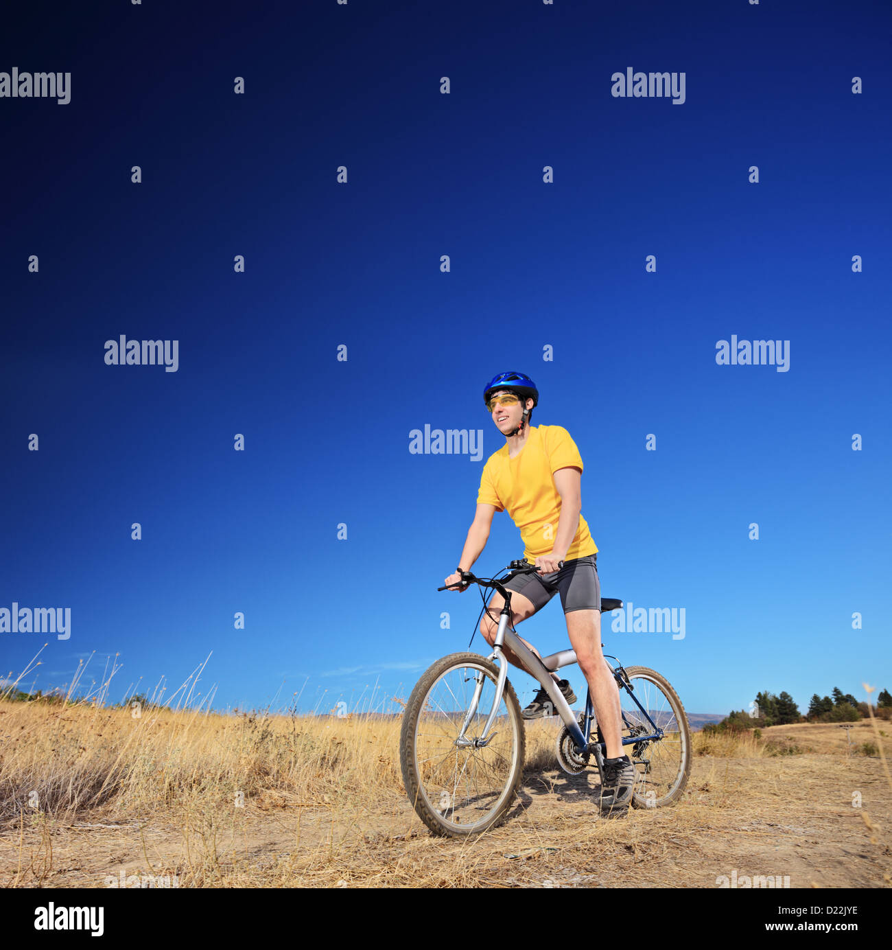 Panning shot of a bicycle rider riding a mountain bike outdoors on a ...