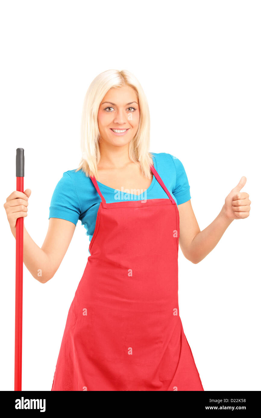Smiling female cleaner giving a thumb up isolated on white background ...