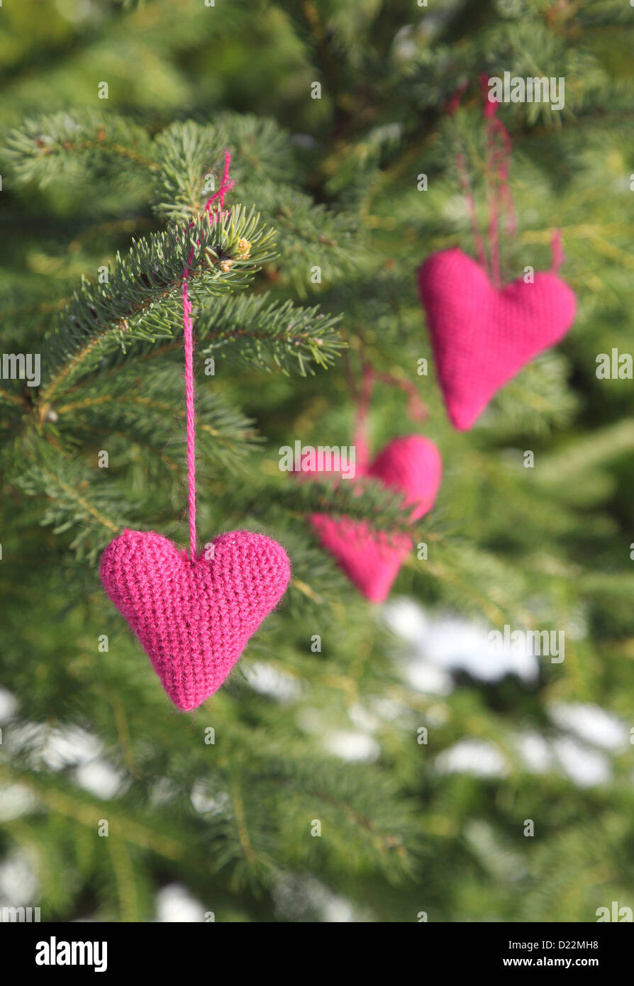 Knitted hearts hanging on a tree branch Stock Photo - Alamy