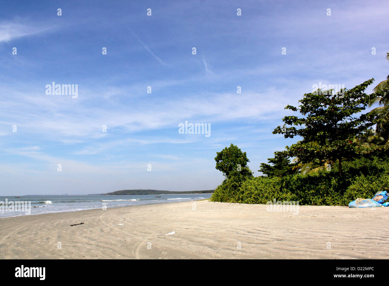 Beach with yellow sand and bright blue sky Kannur Kerala India Stock ...