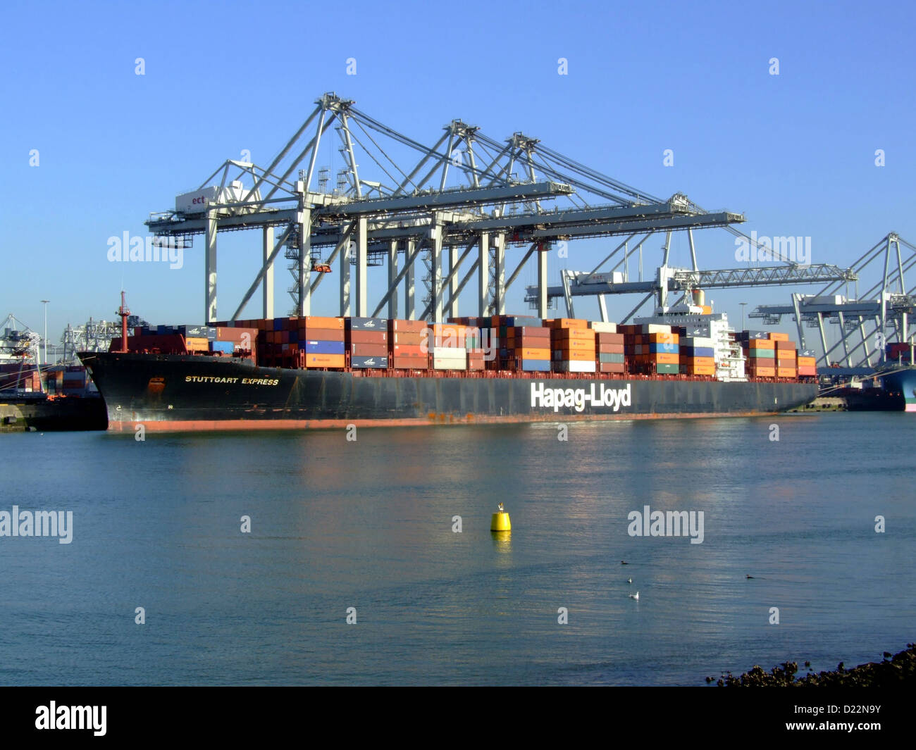The Stuttgart Express, a container ship, is unloading cargo at a port ...