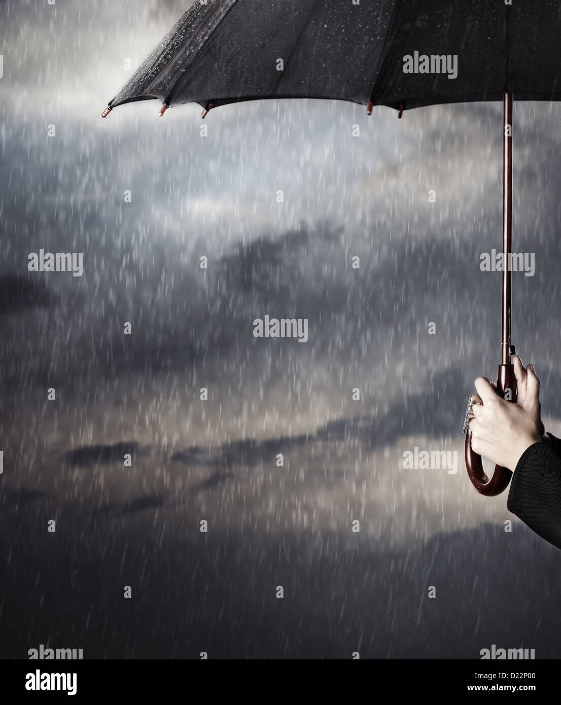 Human hands holding big black umbrella under the heavy rain Stock Photo ...