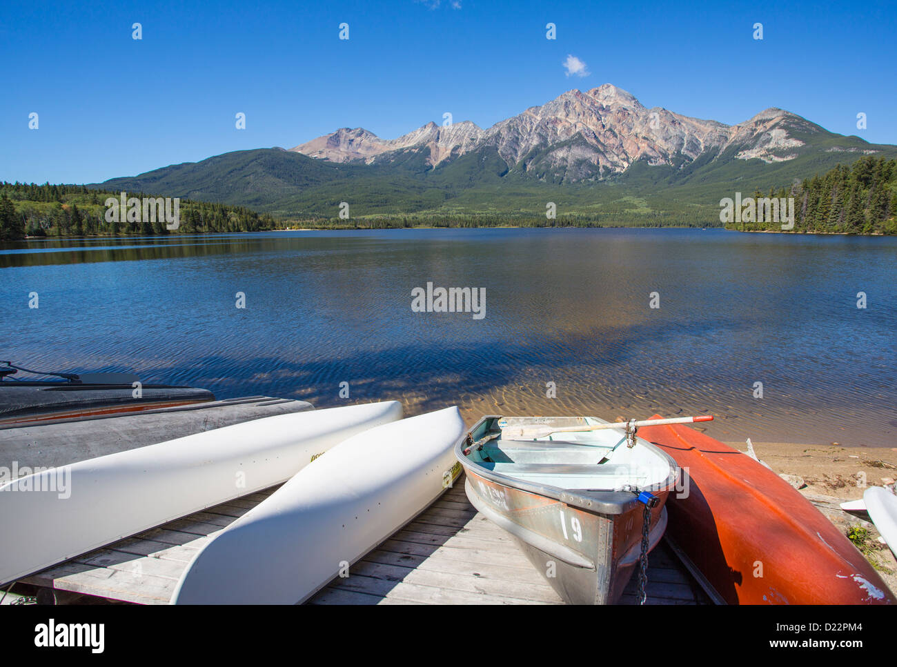 Boats on dock with Pyramind Mountain across Pyramind Lake In Jasper ...