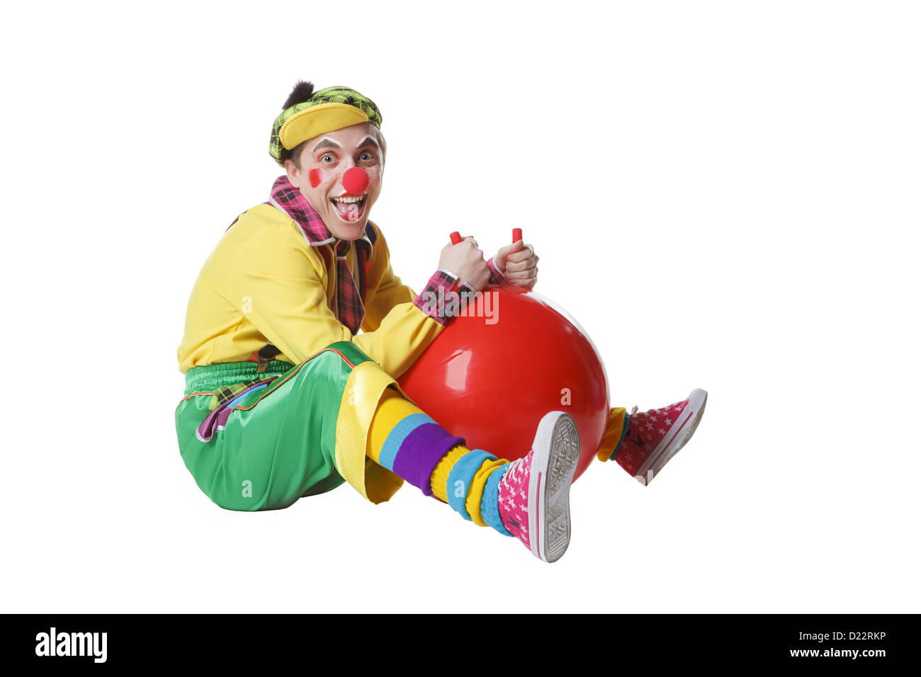 Funny clown with balls in studio isolated on white background Stock ...