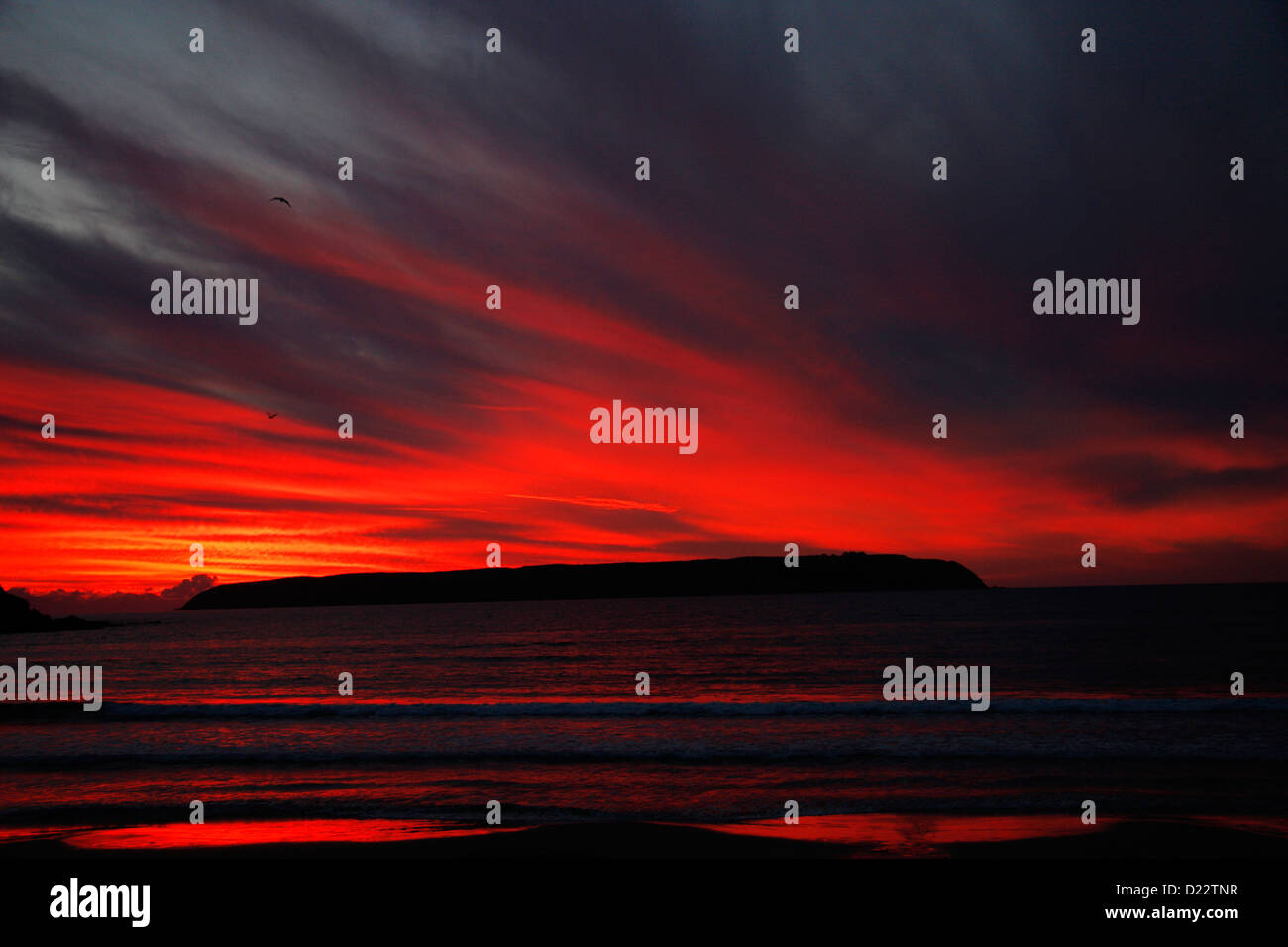 A bright red sky over Mana Island after sun-set, shot from Titahi Bay ...