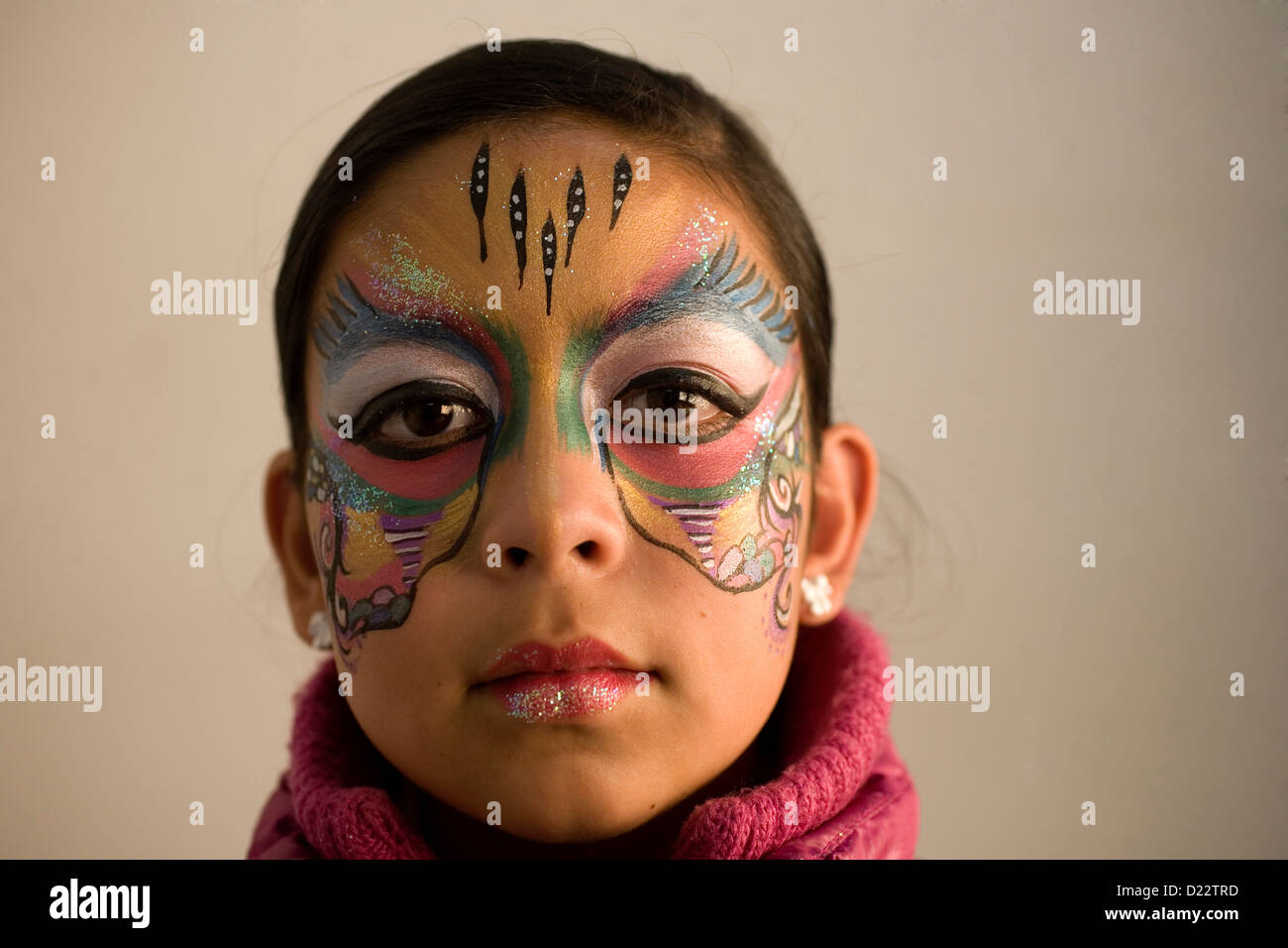 A girl poses for a face painting session with make-up artist Erika ...