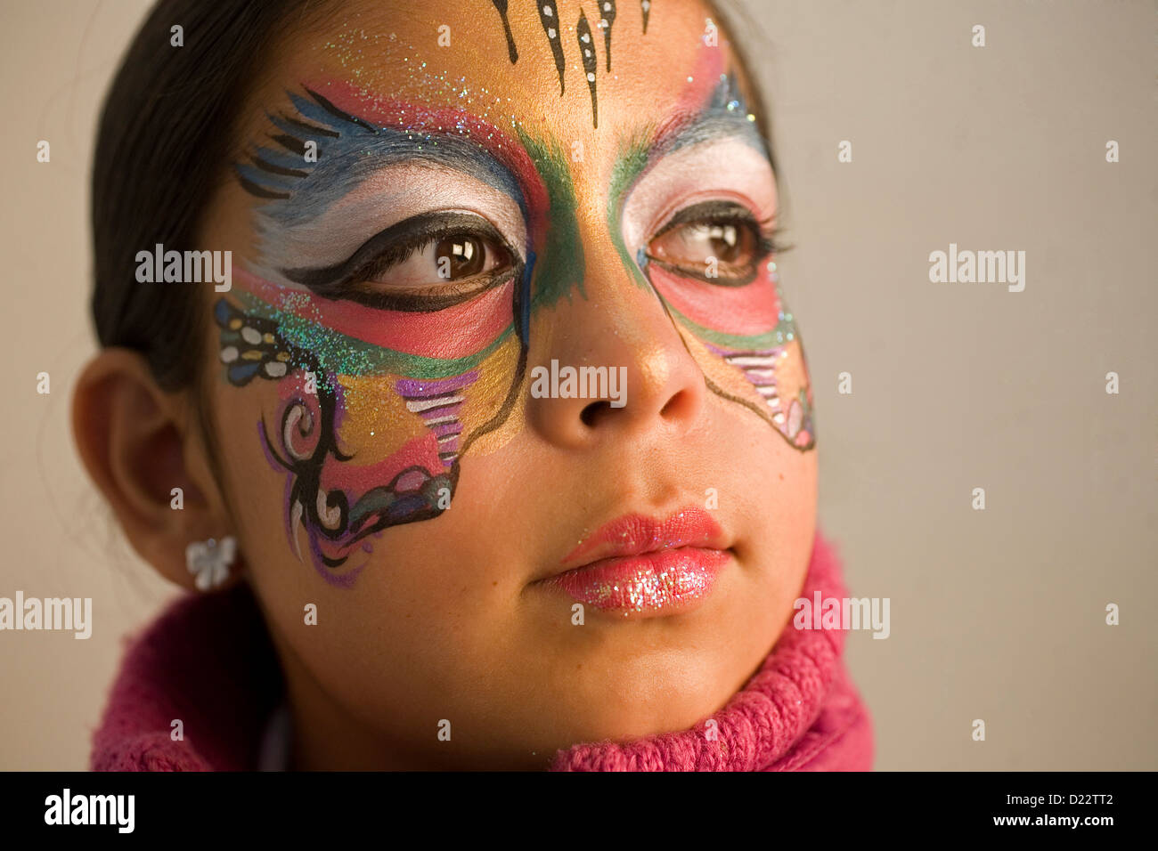 A girl poses for a face painting session with make-up artist Erika ...