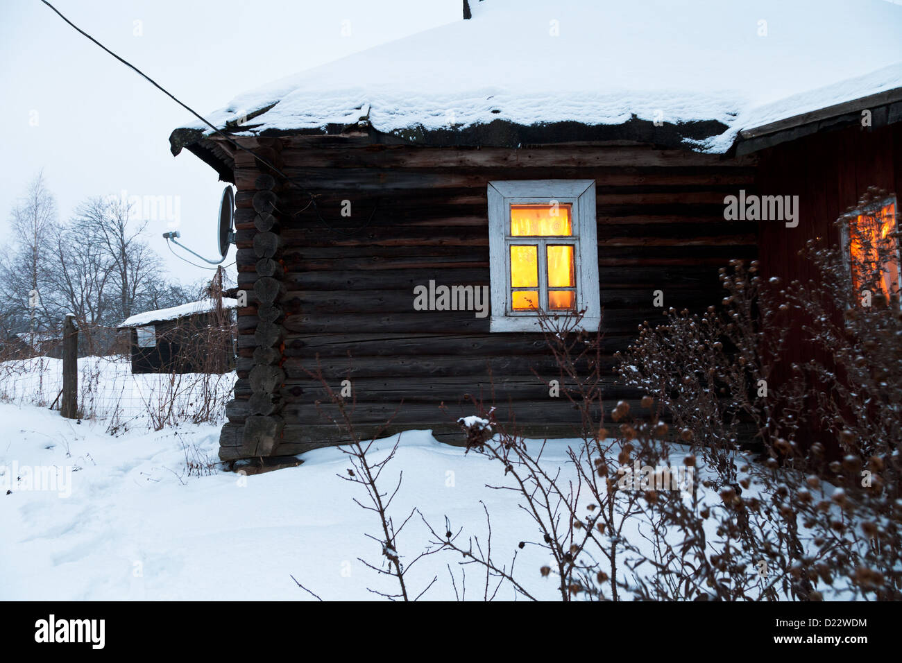 yellow lighting window of rural house at blue winter gloaming Stock ...