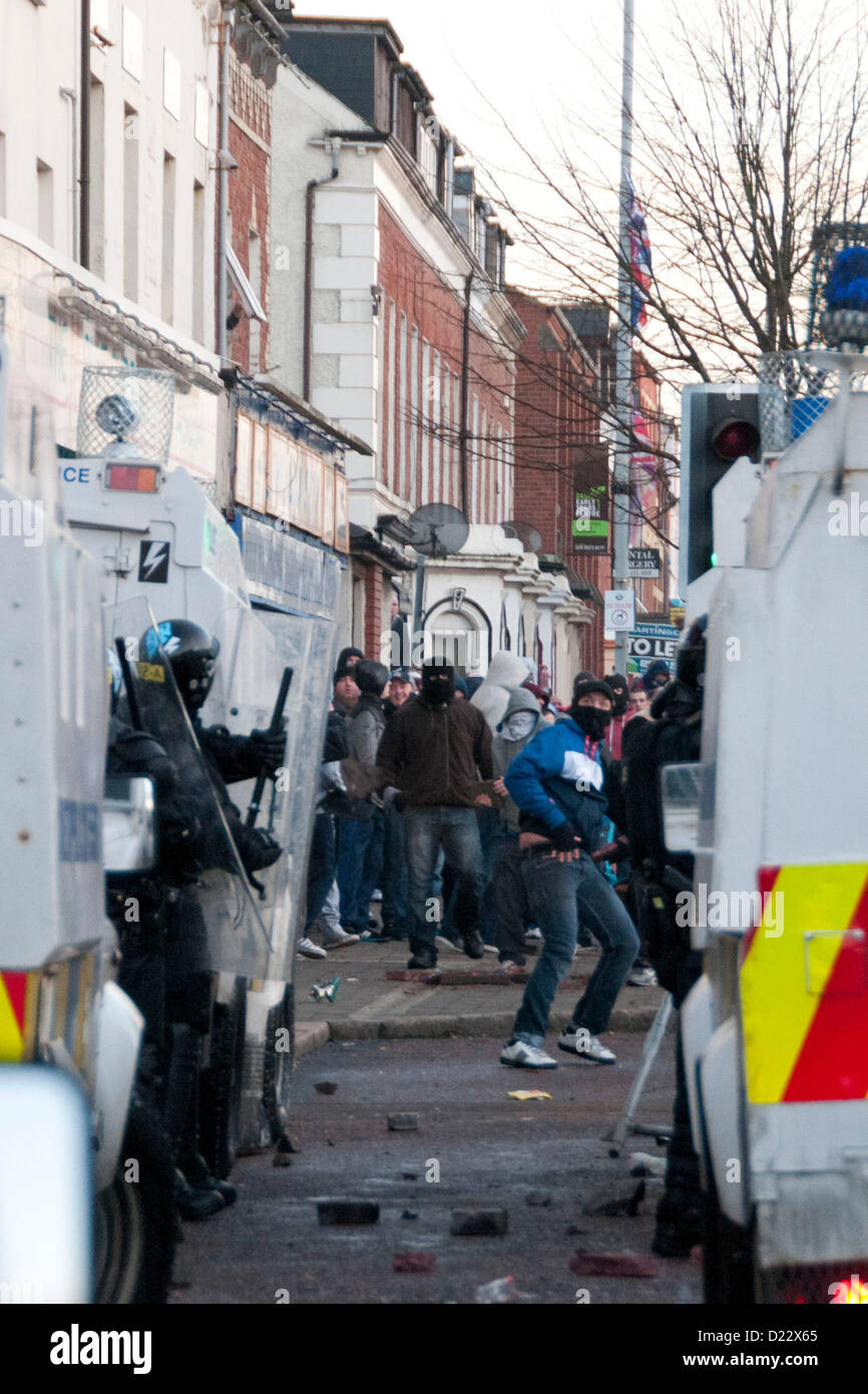 Belfast, UK. 12/01/13. Loyalist youths pelt police with rocks, bottles ...