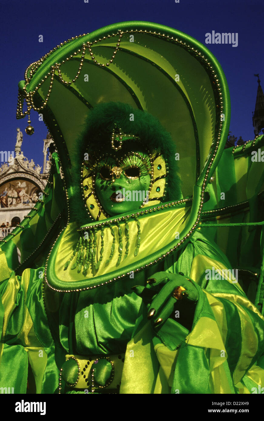 A person wearing a lavish green masked carnival costume during the ...