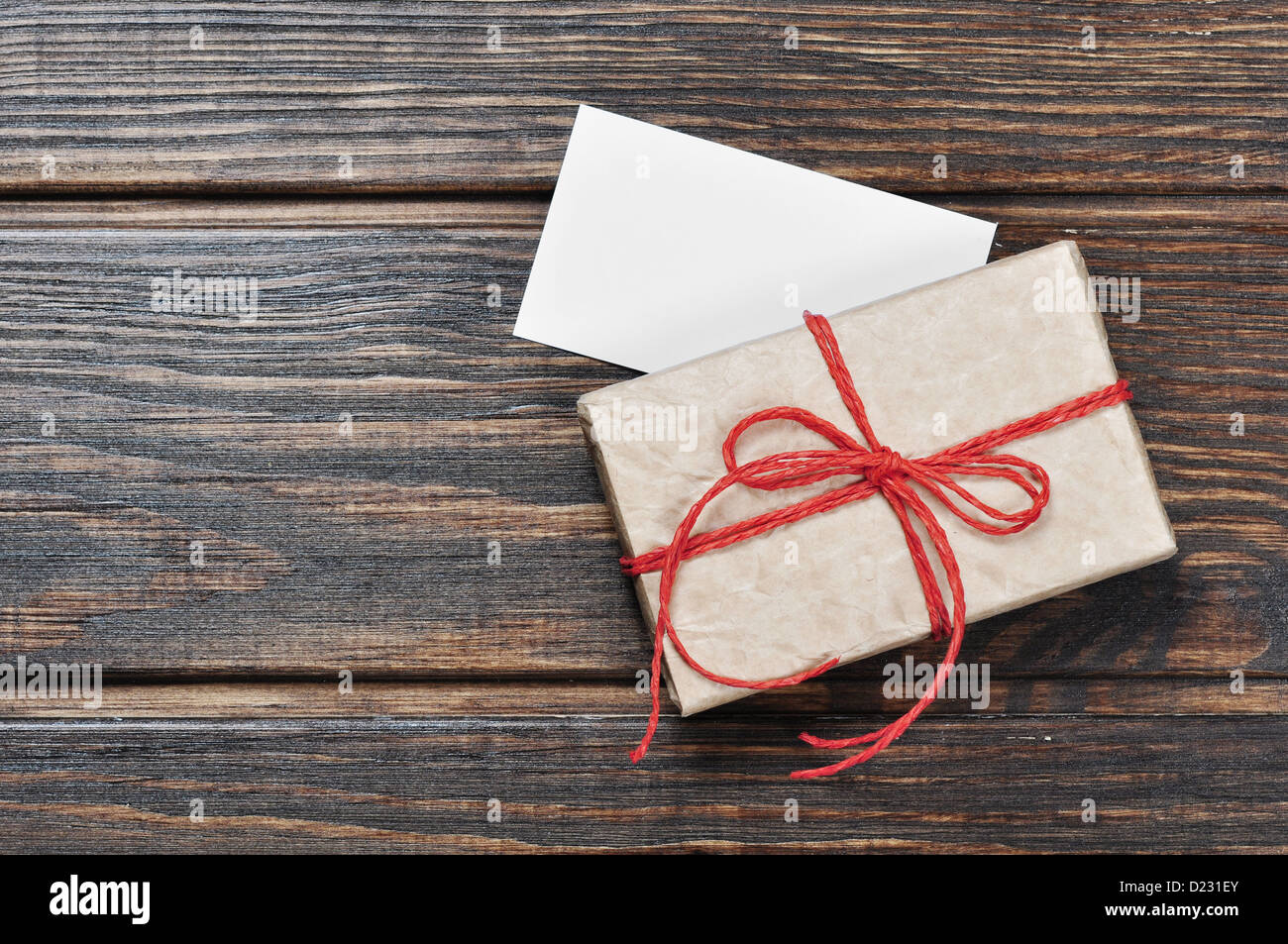 Vintage gift box with red ribbon on wooden background Stock Photo - Alamy