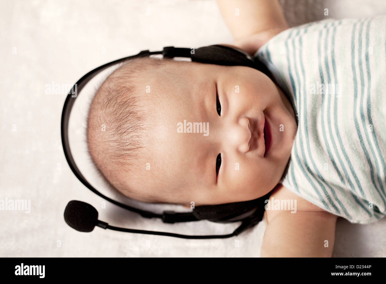 A baby wearing a headset Stock Photo - Alamy