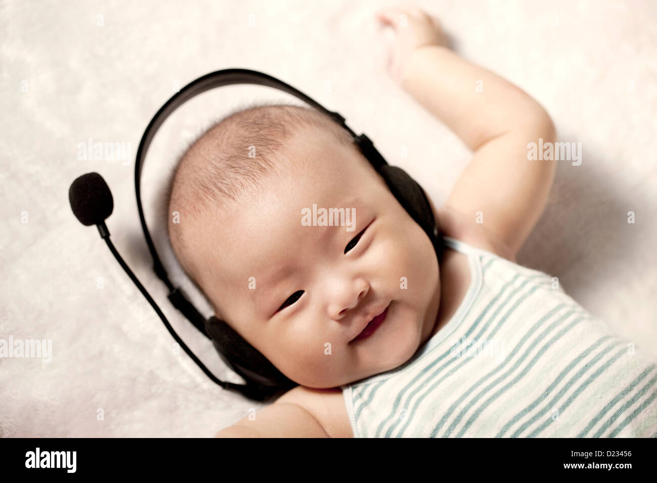 A baby wearing a headset Stock Photo - Alamy