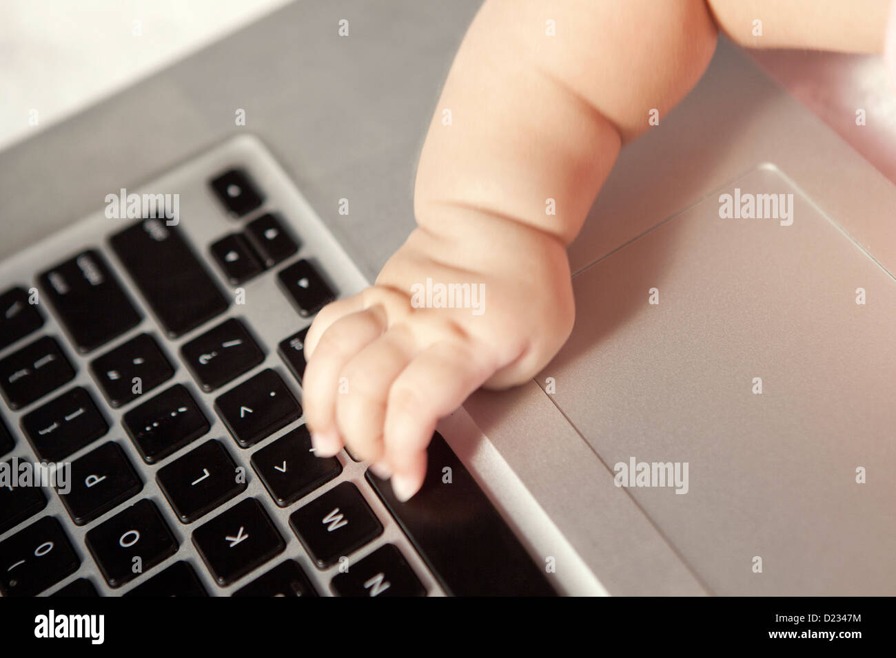 Baby touching laptop keyboard hi-res stock photography and images - Alamy