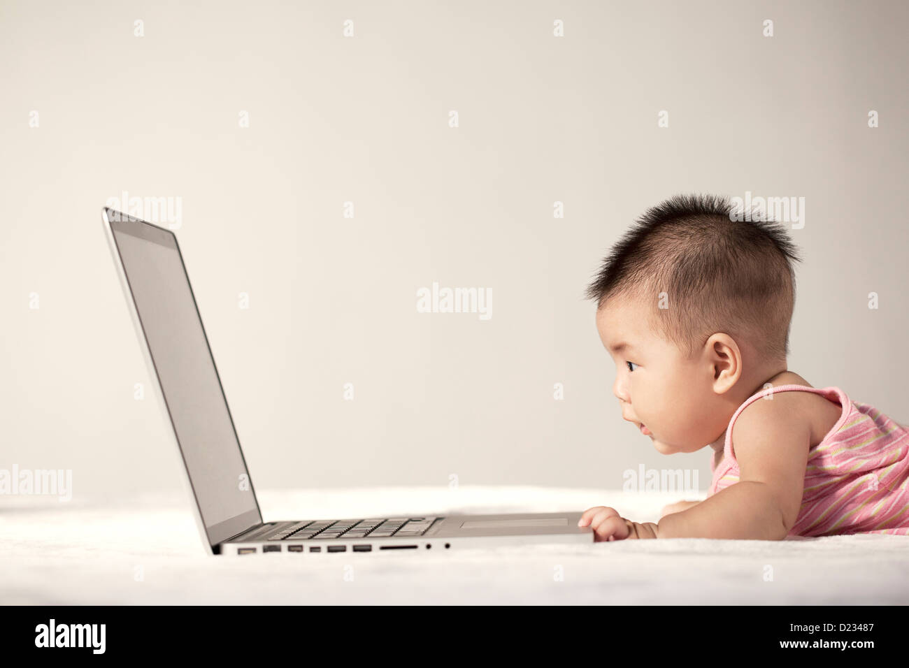 A baby and a computer Stock Photo - Alamy