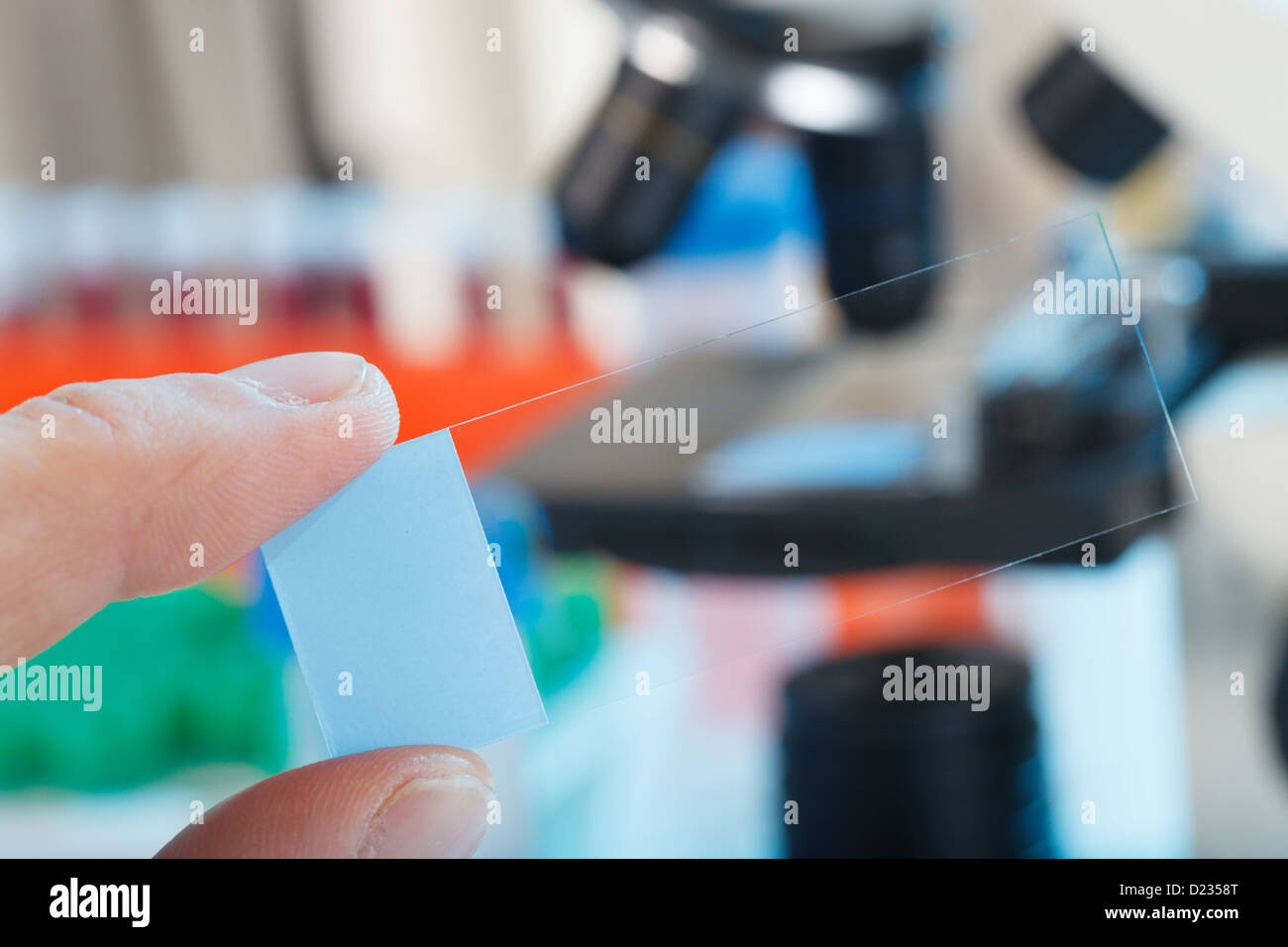 Object plate in hand in mocroscope background Stock Photo - Alamy