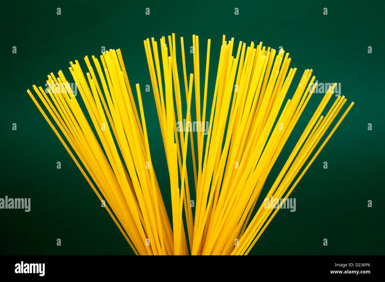 Spaghetti over green background Stock Photo - Alamy