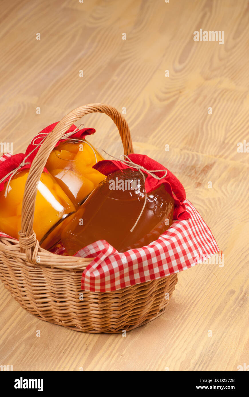 Traditional basket with autumn harvest products in jars Stock Photo - Alamy