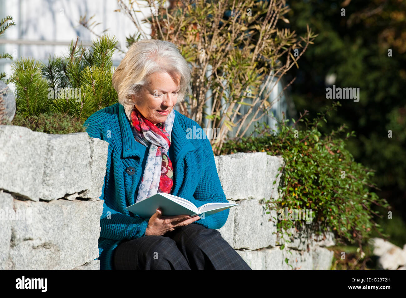 Elderly woman in the garden Stock Photo - Alamy