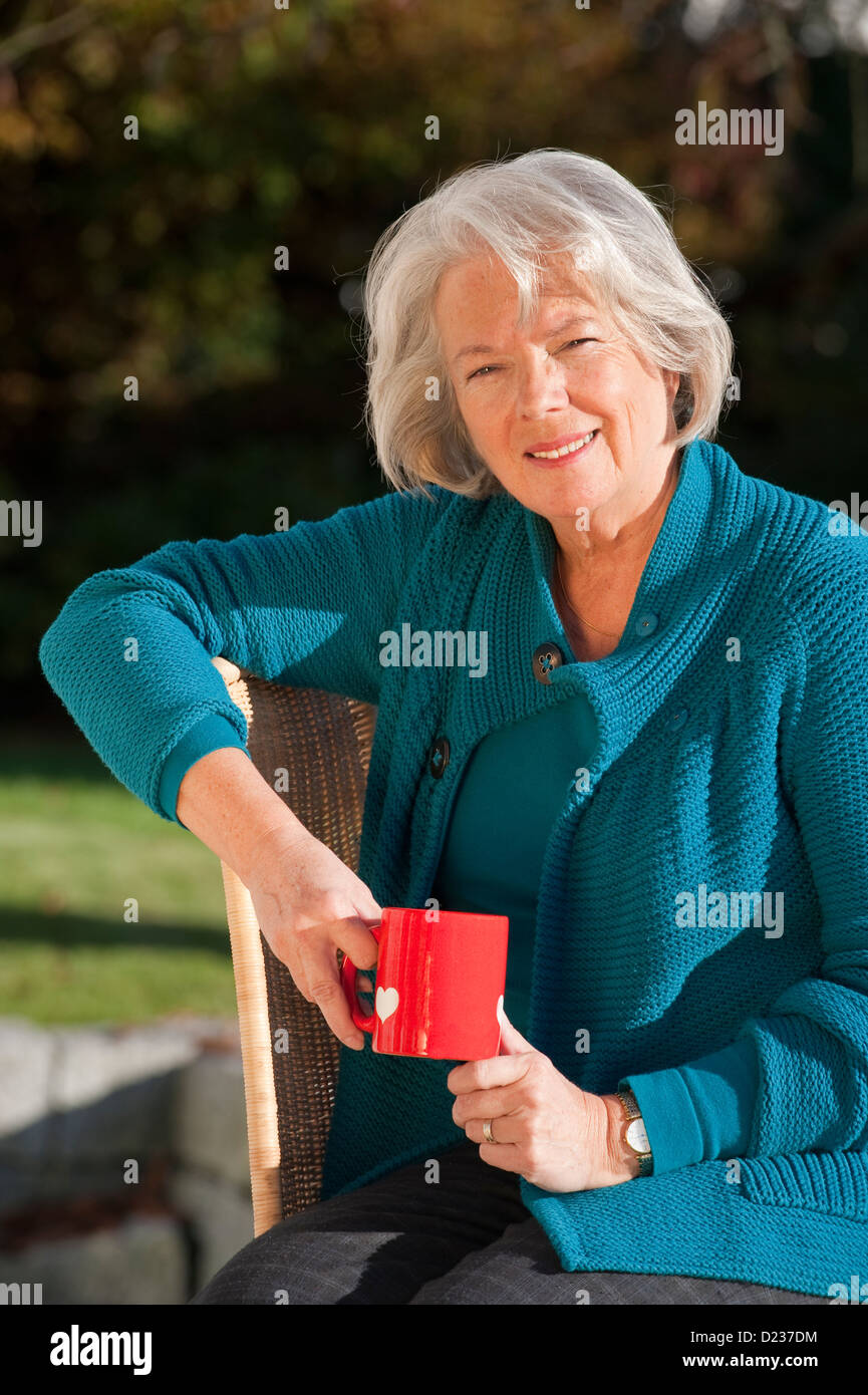 Elderly woman in the garden Stock Photo - Alamy