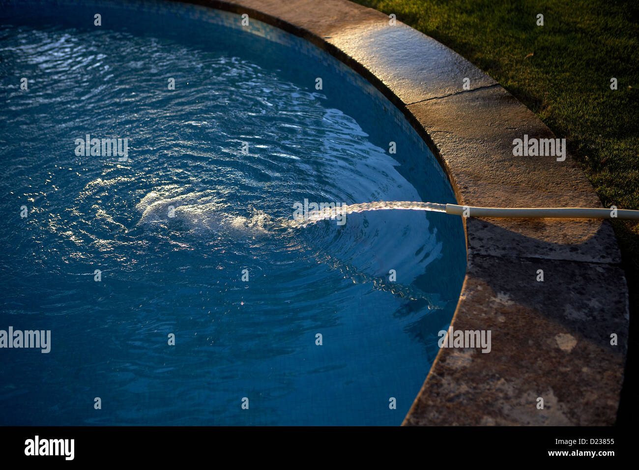 Filling a pool with a hosepipe Stock Photo - Alamy