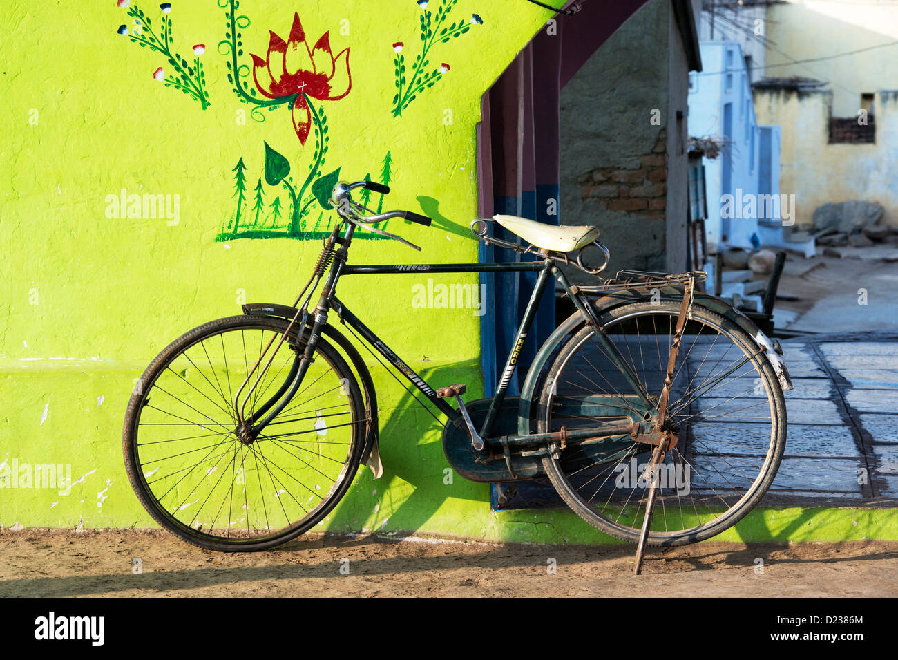 Traditional Indian bicycle against a green Indian house. Andhra Pradesh ...