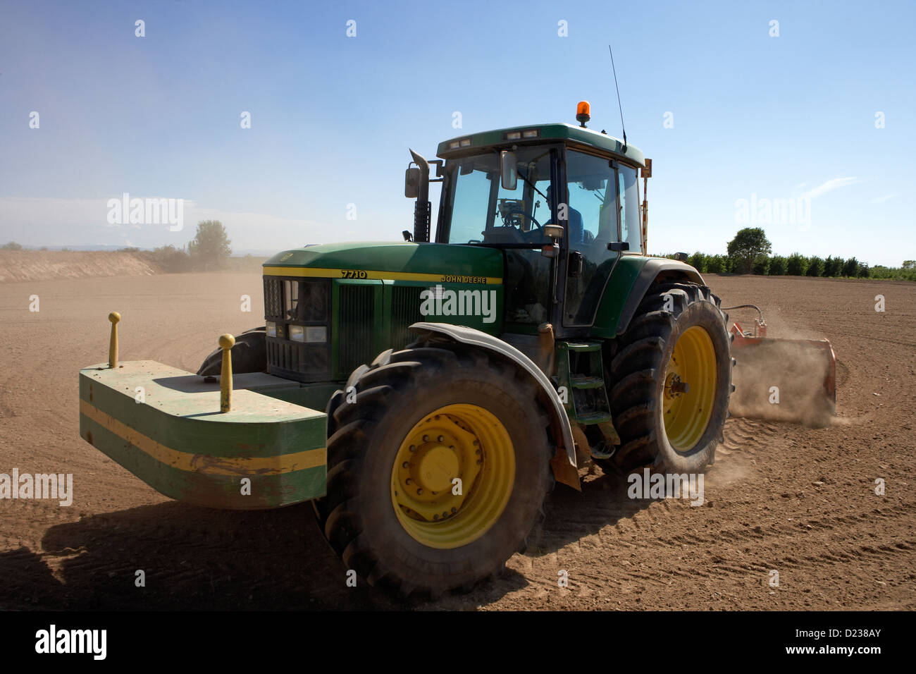 Tractor with laser machine working on level a field. LLeida. Spain ...