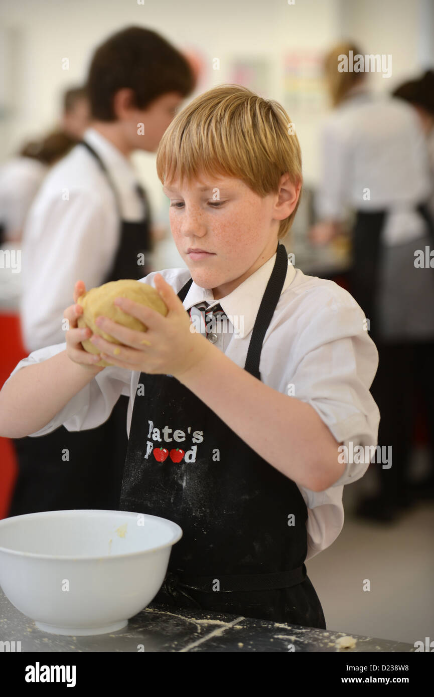 A boy kneading dough during a Food Science lesson at Pates Grammar ...